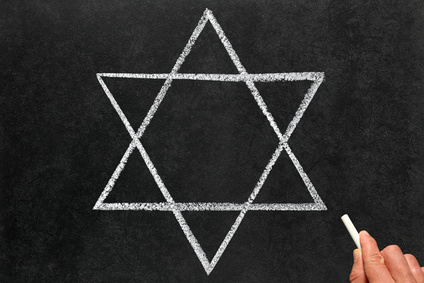Drawing Star of David Judaism religious symbol on a blackboard. - Sixth & I